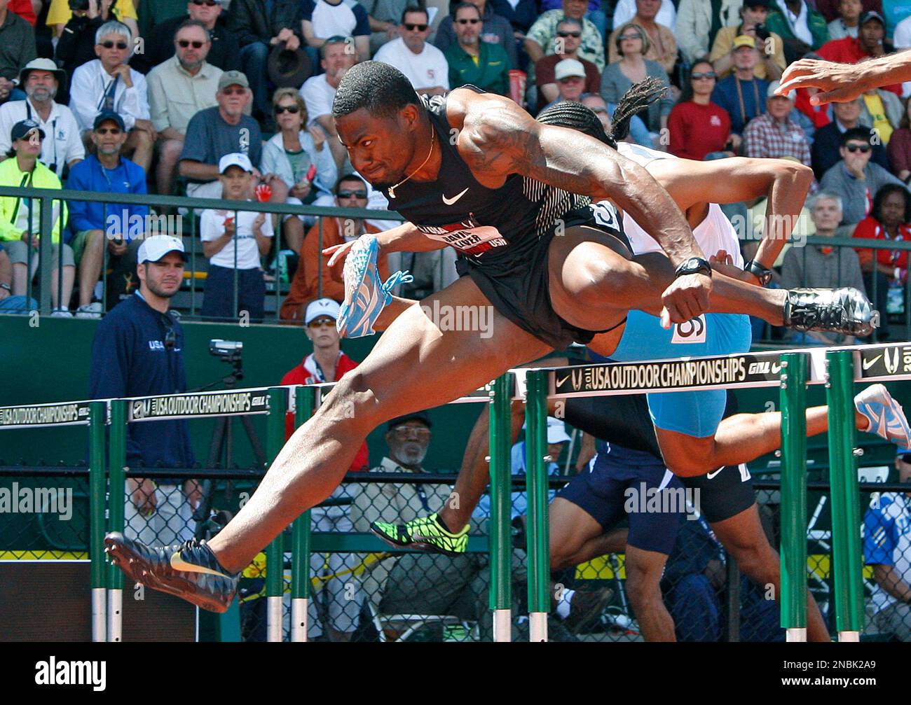 David Oliver clears a hurdle on his way to winning the men's 110 ...