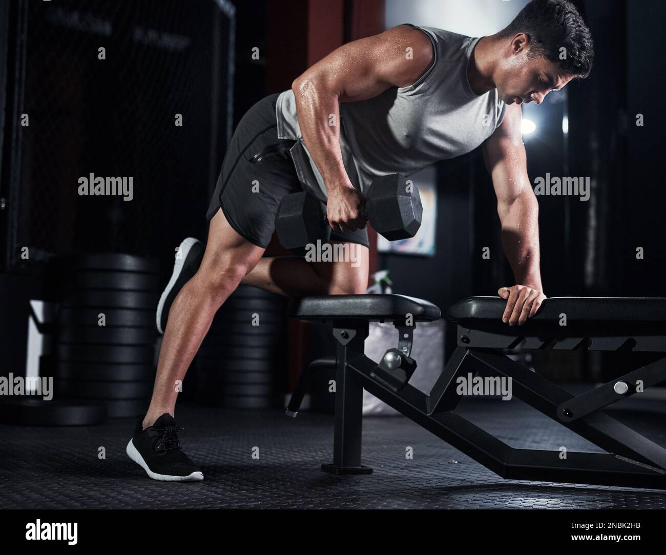 Maintaining a strong body takes effort. a muscular young man exercising ...