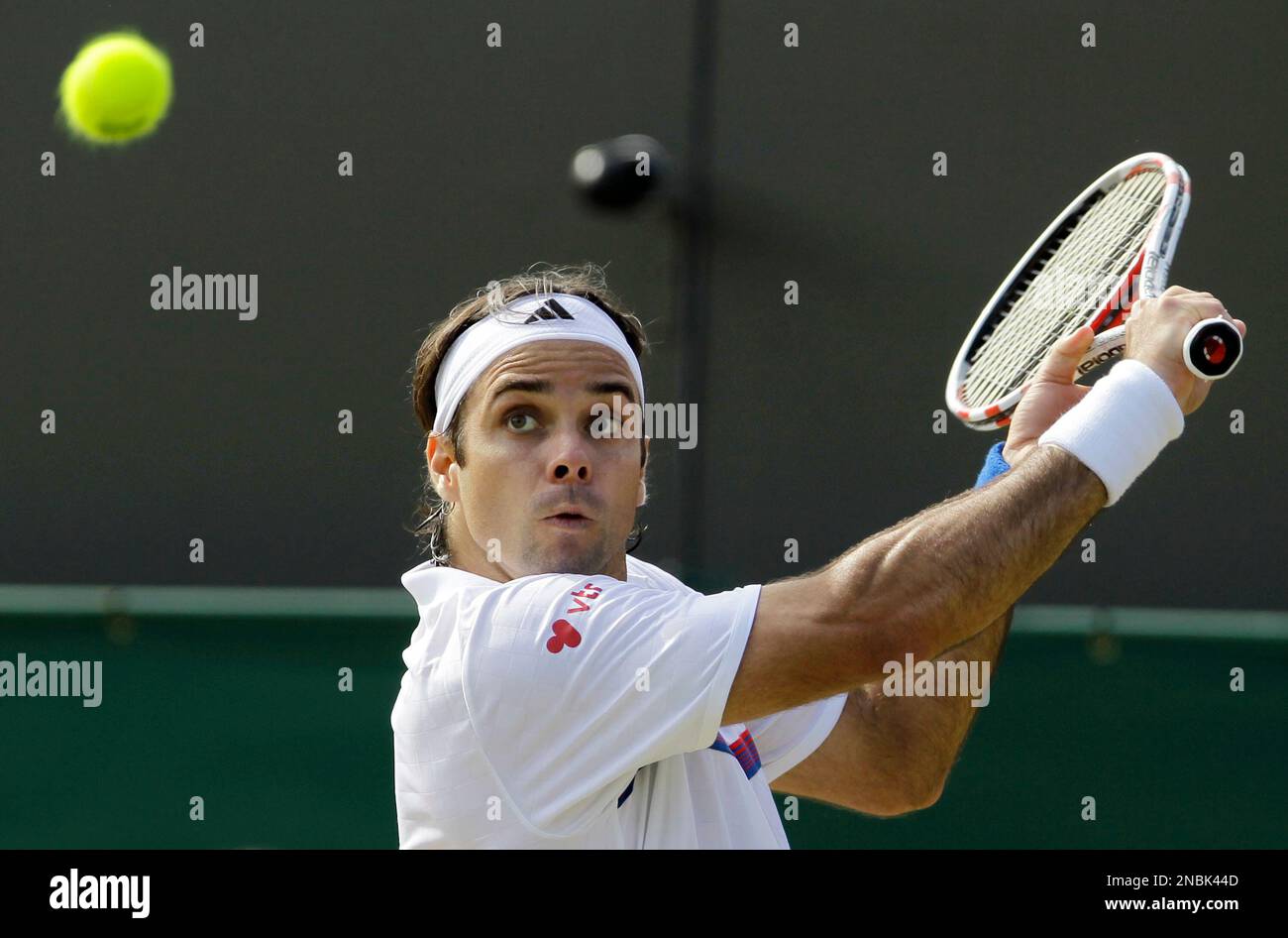 Chile's Fernando Gonzalez returns a shot to France's Jo-Wilfried Tsonga ...