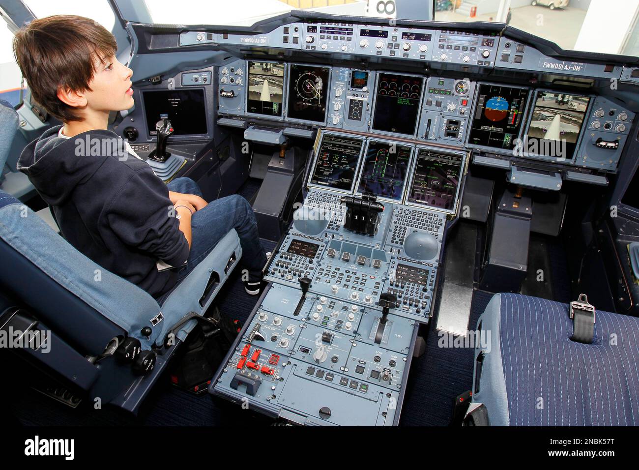 Visitor Mathieu Salliot, 13 years old, from Paris, sits in the cockpit ...