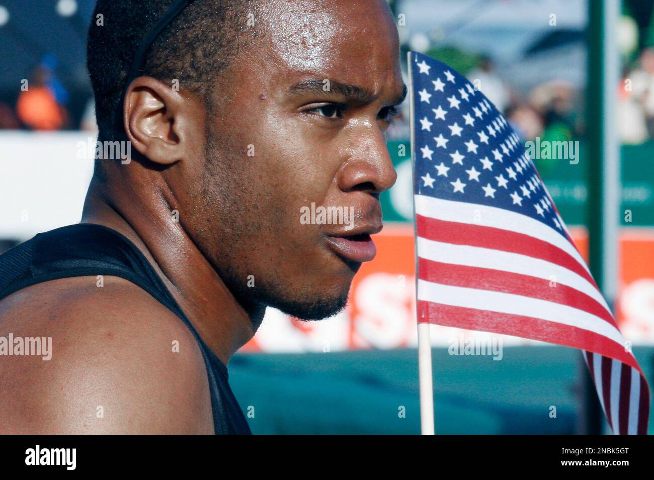 Walter Dix poses with a American Flag after winning the 100-meter race ...