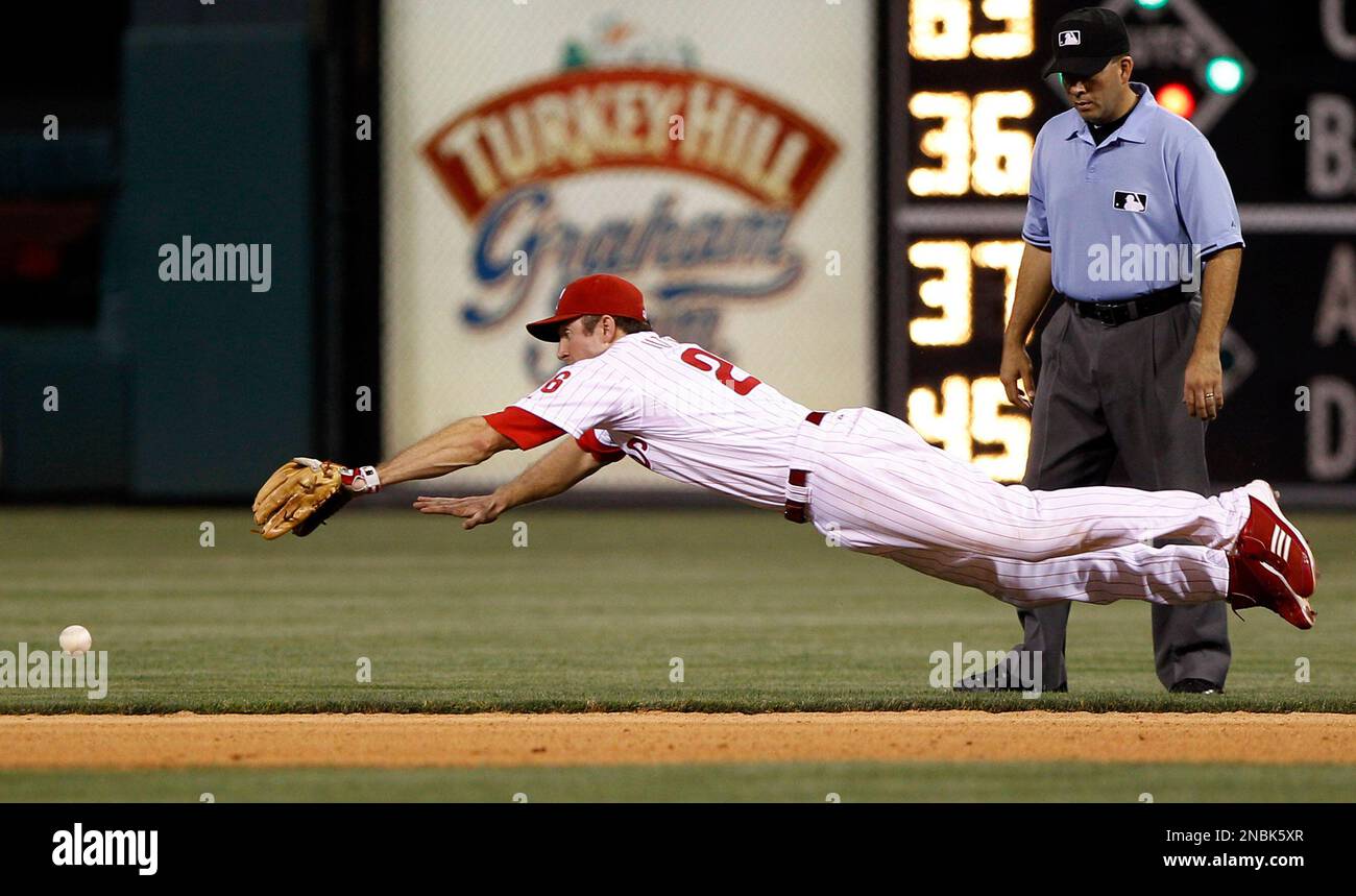 Philadelphia Phillies second baseman Chase Utley, left, cannot reach a ...