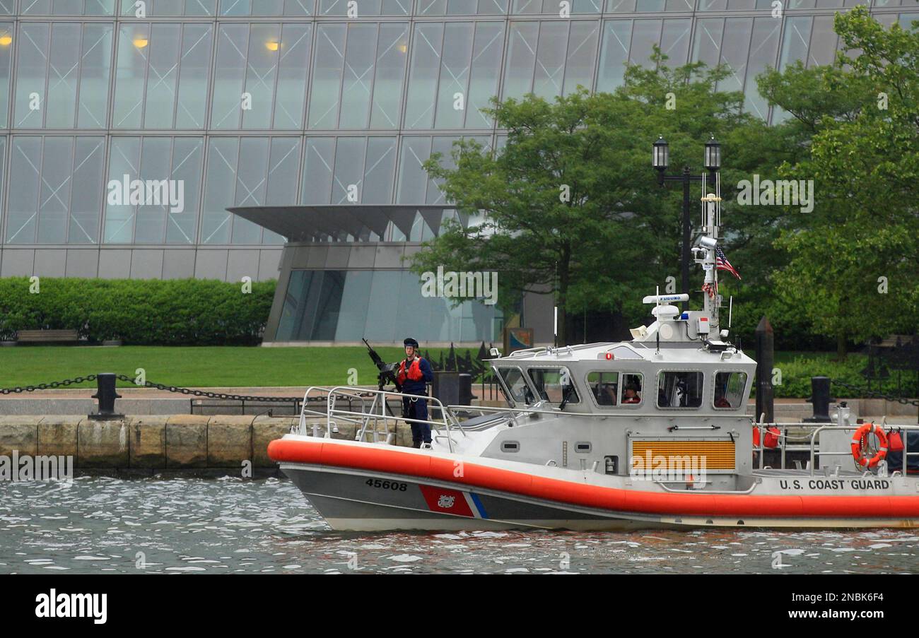 A U.S. Coast Guard patrol boat, with a machine gun mounted on the bow ...
