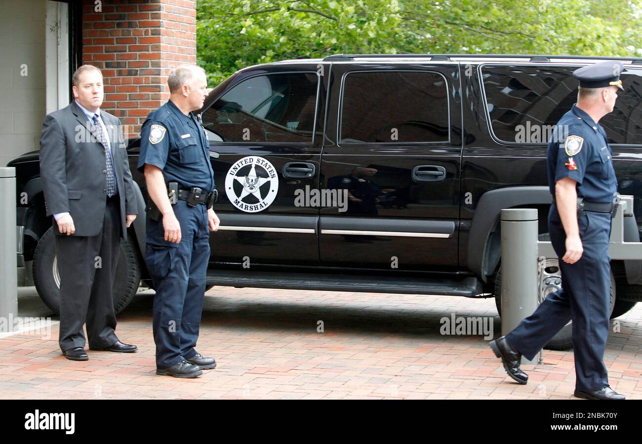 The second of two law enforcement vehicles in a convoy transporting ...