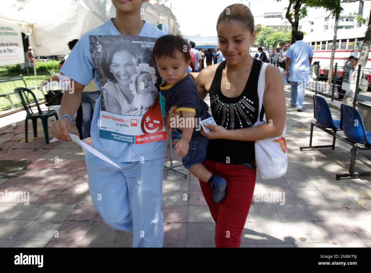 Health worker Romeo Hernandez, right, leads Carla Ventura and her son ...