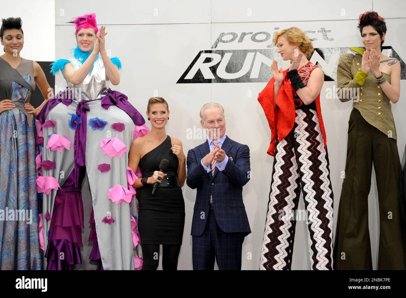 Host Heidi Klum, center, and mentor Tim Gunn, surrounded by models on ...