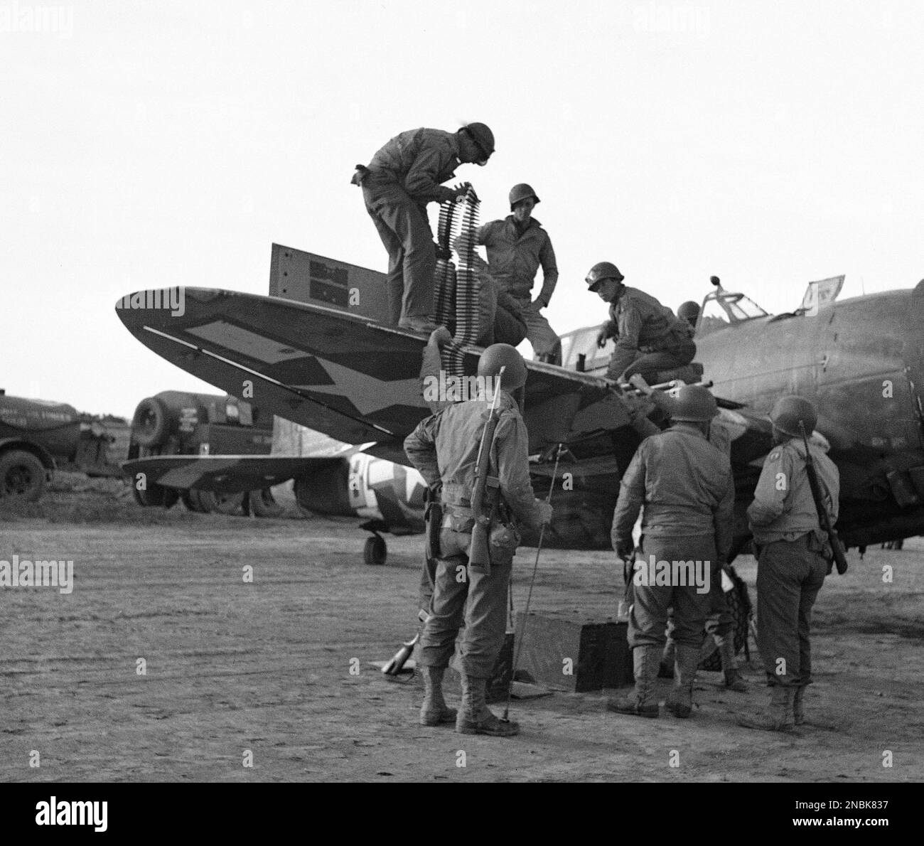 The re-arming of a P-47 with 50 caliber ammunition, as the P-47 group ...