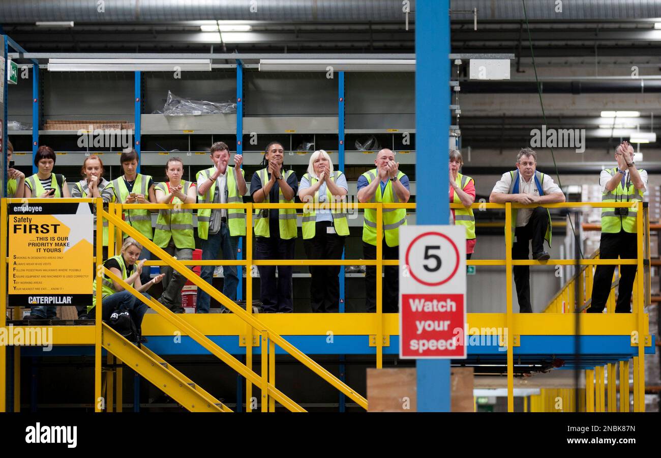 Members of staff applaud as the British Broadcasting Corporation's ...
