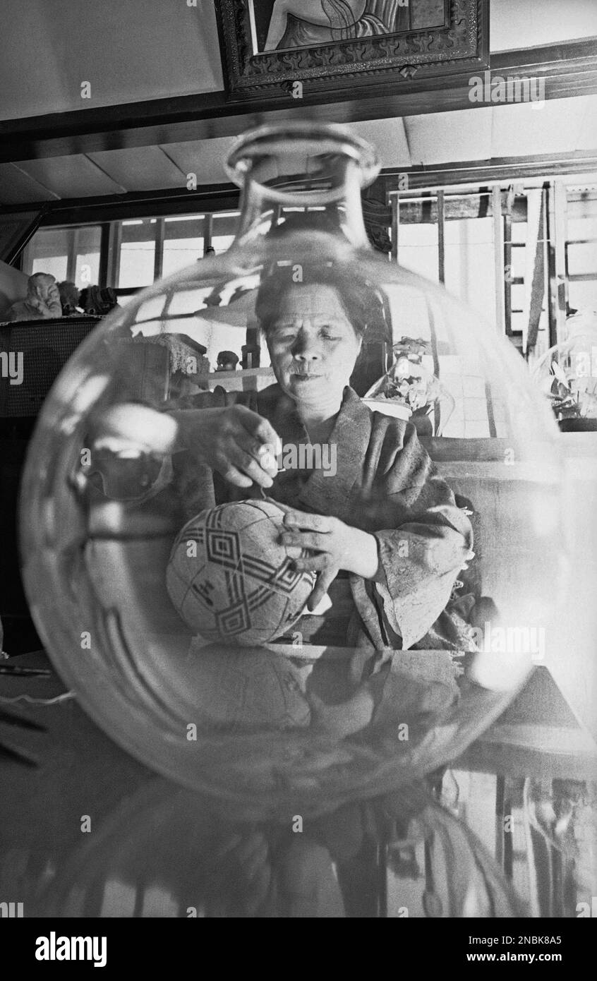 “Temari,” Japanese traditional colorful ball, is put in a bottle ...