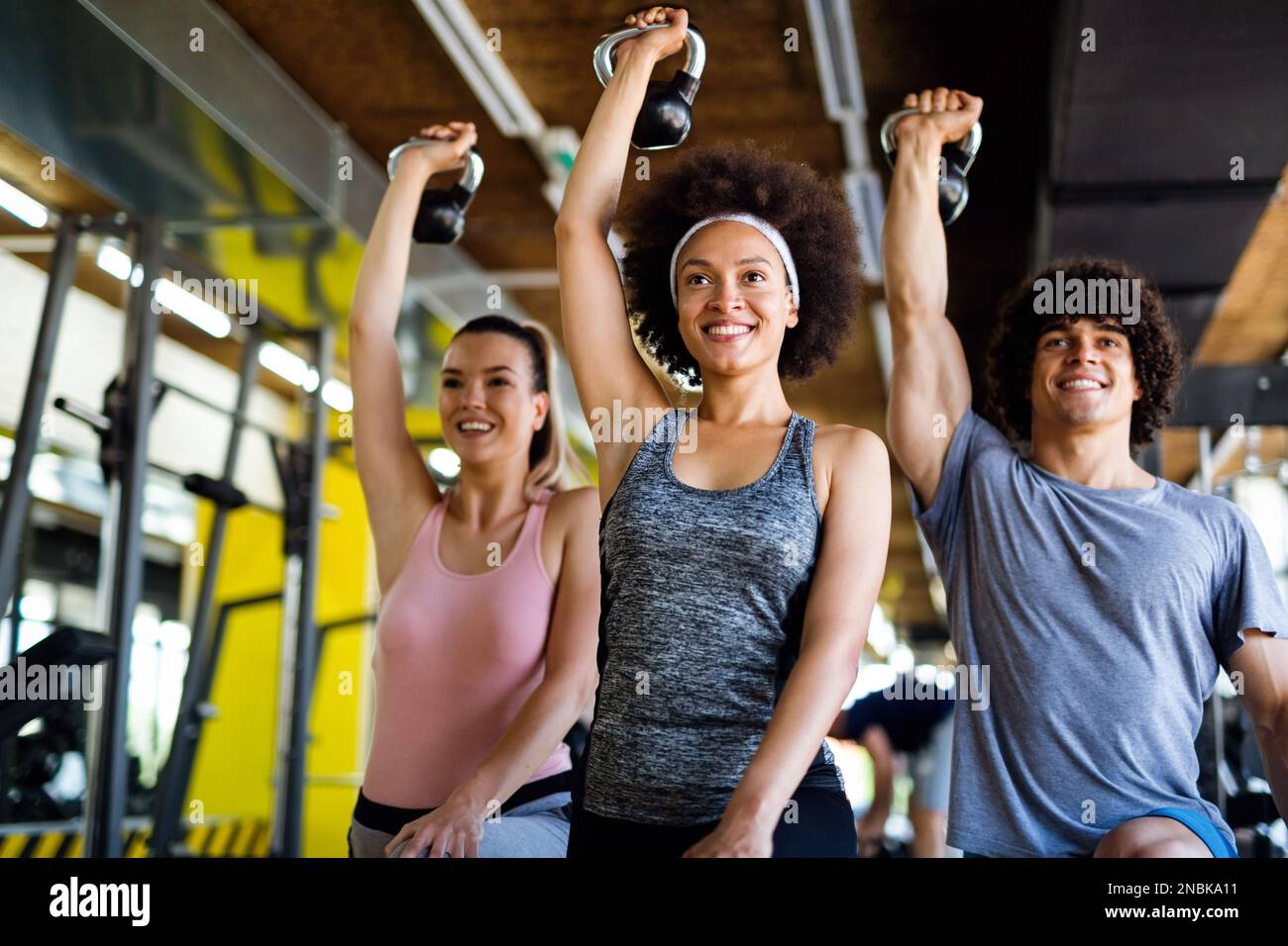 Group of fit people working out in a gym. Multiracial friends ...