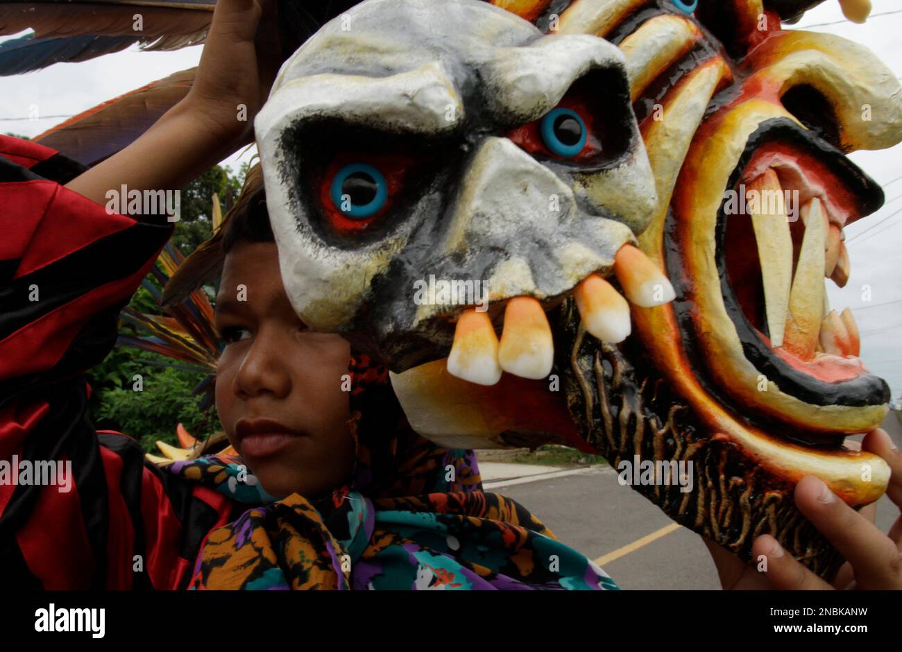 A boy holds up a devil mask during Corpus Christi celebration in La ...