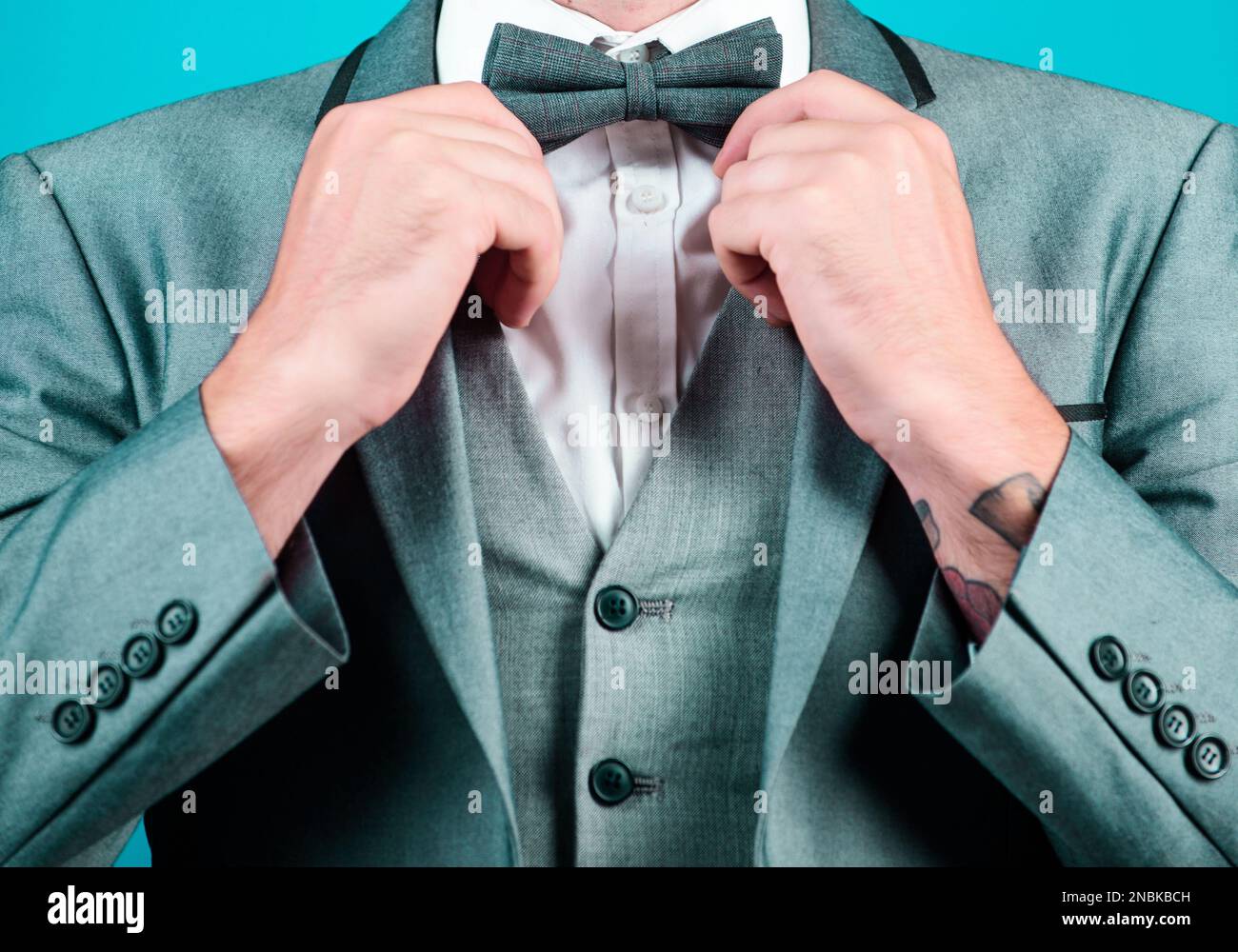 Man adjust suit with bow tie. Formal suit jacket close up. Male fashion ...