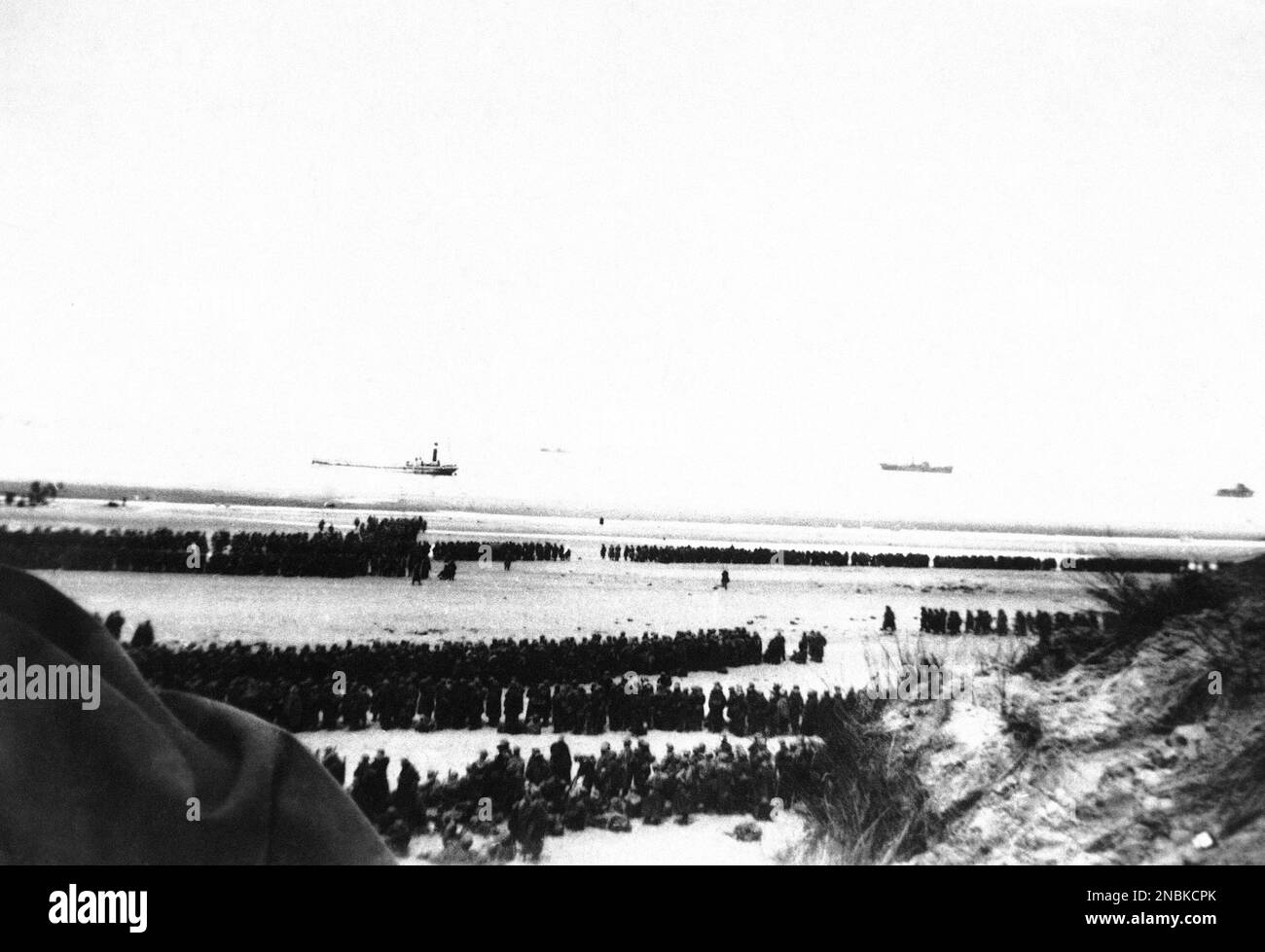 Thousands of British and French troops drawn up on the sandy beach at ...