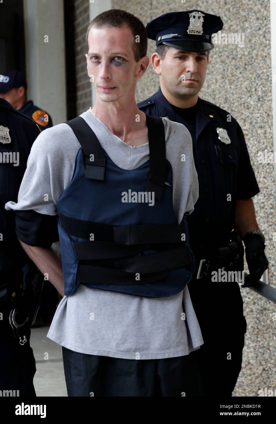 David Laffer, is escorted out of a police station in Patchogue, N.Y ...