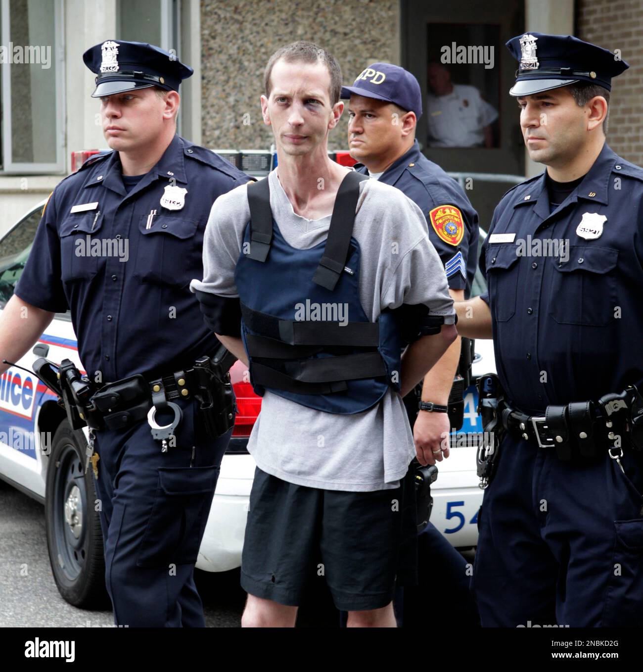 David Laffer, is escorted out of a police station in Patchogue, N.Y ...