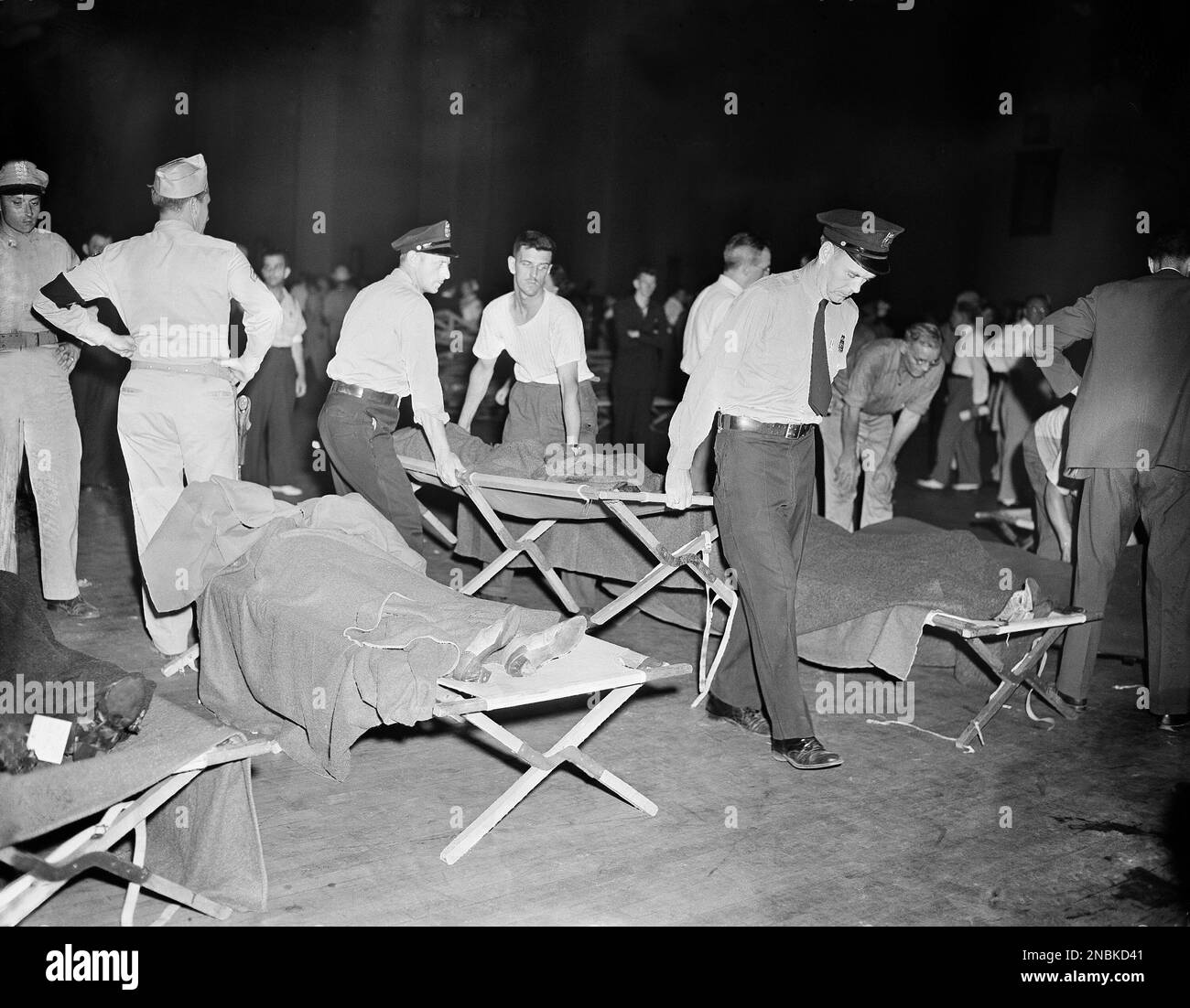 Rescue workers bring the bodies of victims of the circus blaze into an ...