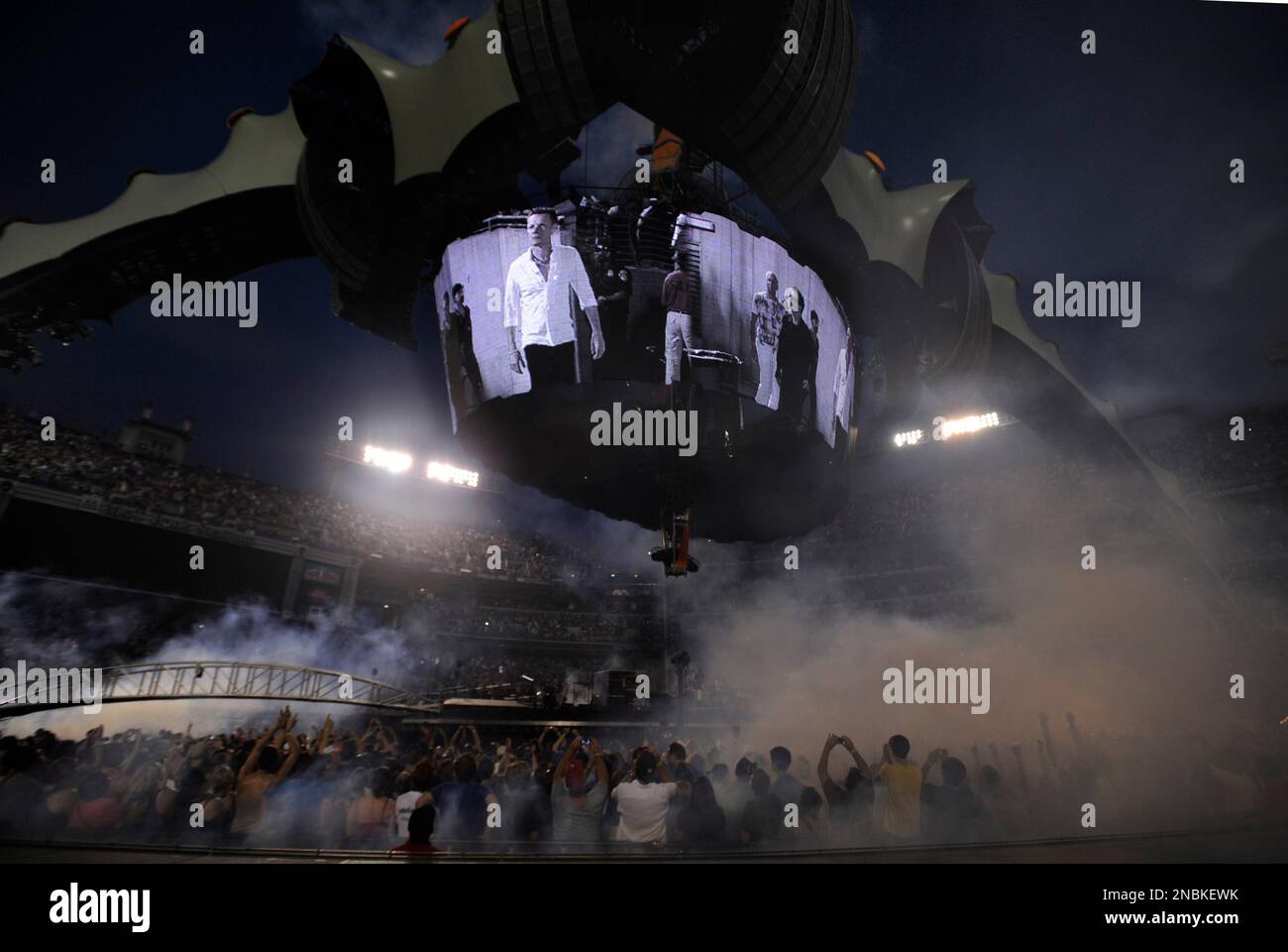 Smoke fills the stage as a projection of Bono makes his way to the ...
