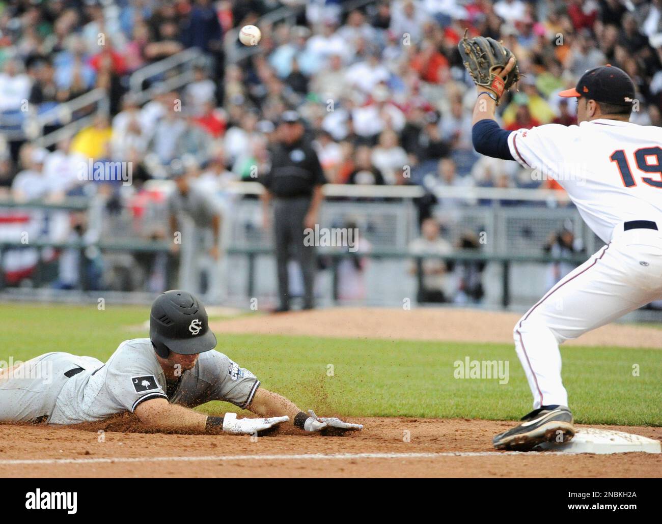 South Carolina's Jake Williams slides to third base on a triple as ...