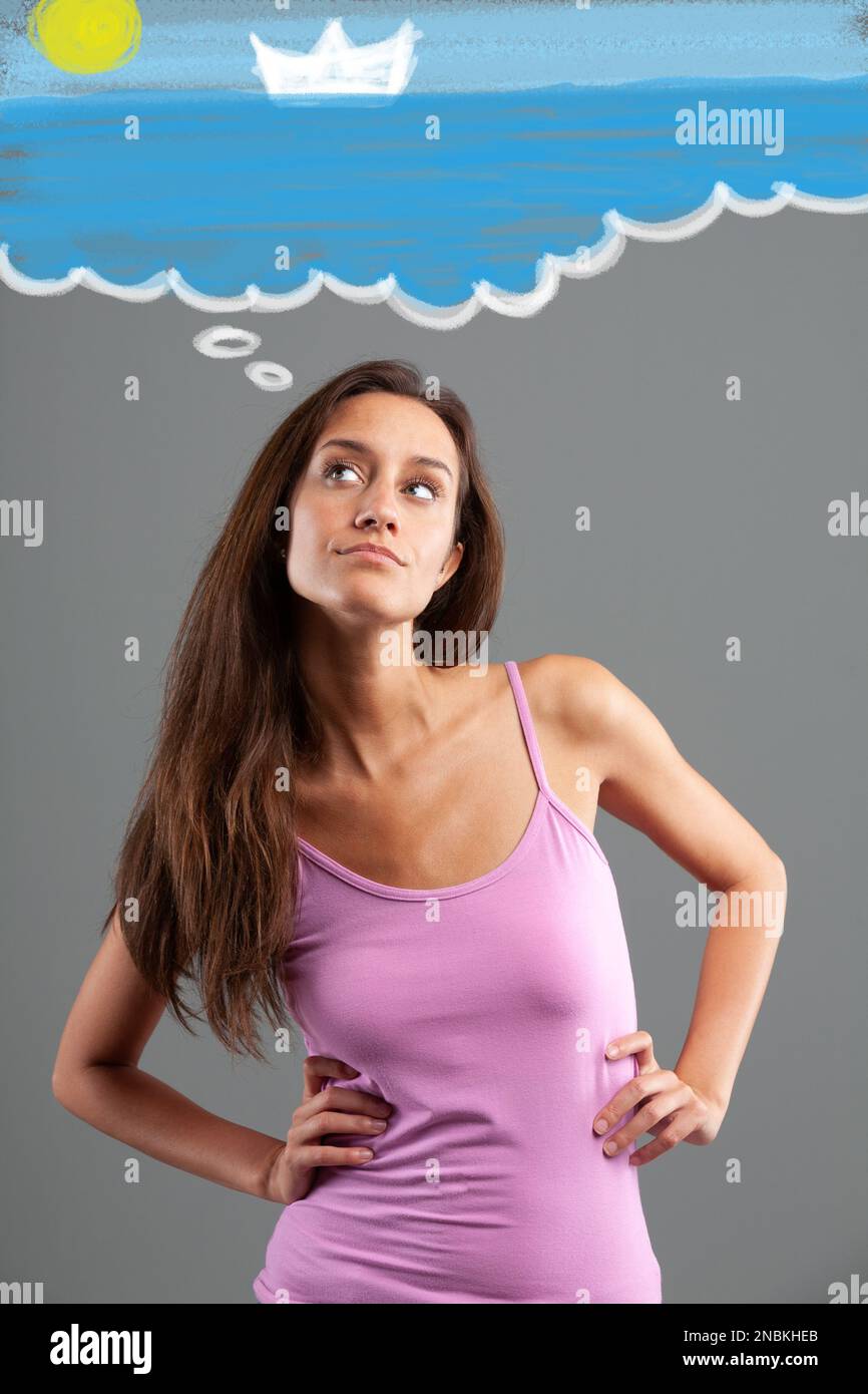 slender young woman with long hair wears a pink tank top; she has her ...