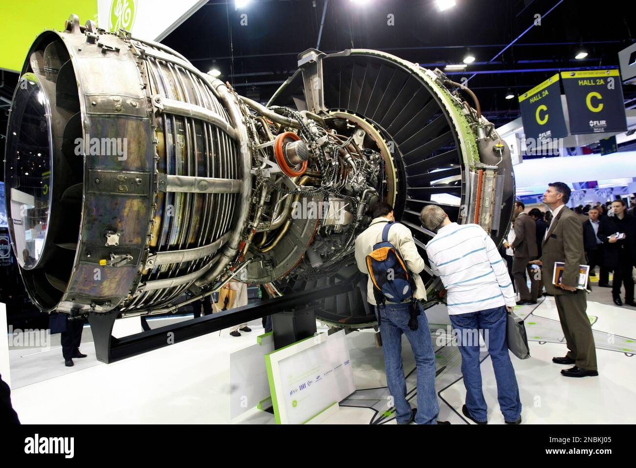 Visitors take a look at the General Electric GEnx jet engine which will ...