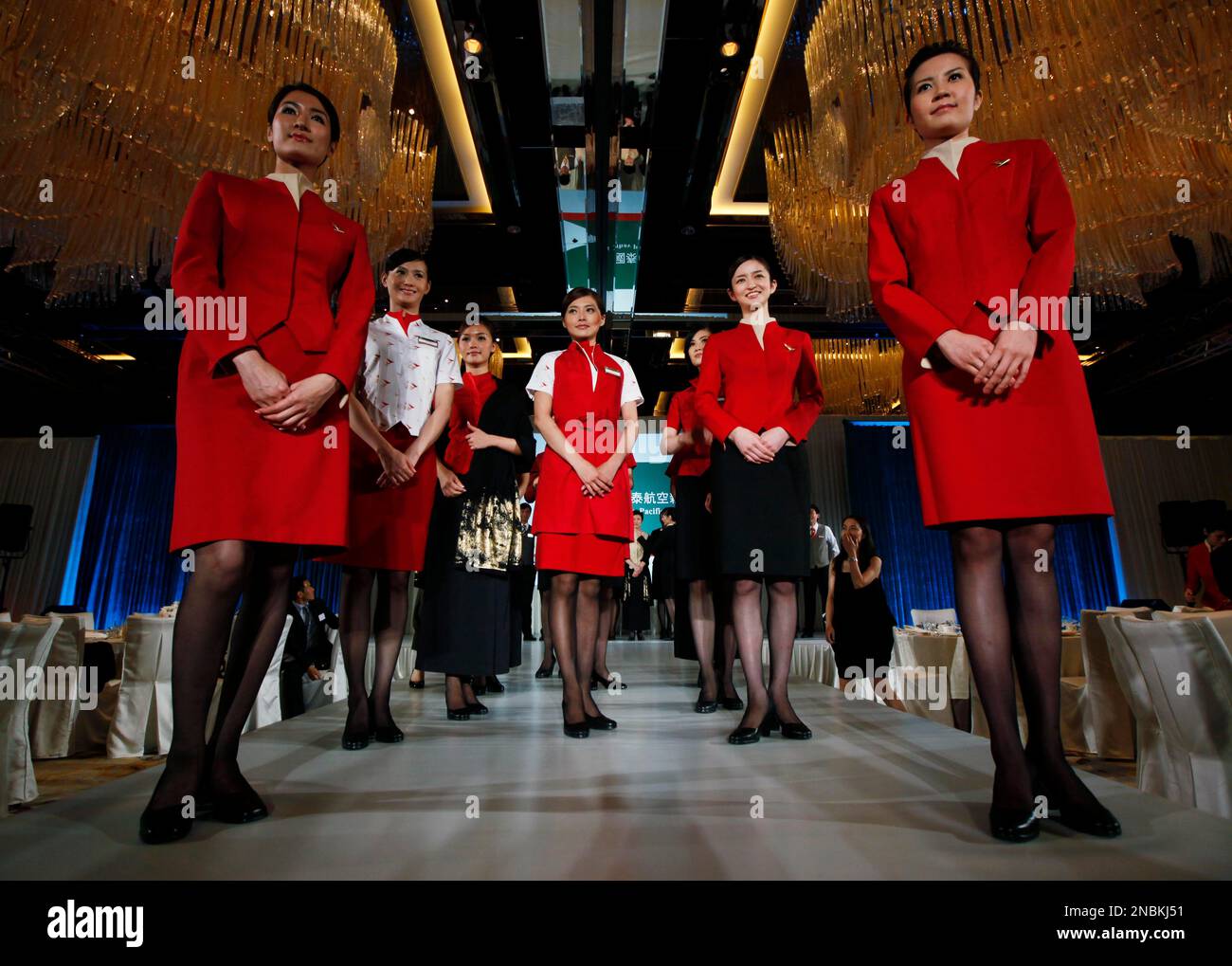 Cathay Pacific staff members present the new uniform at a news ...