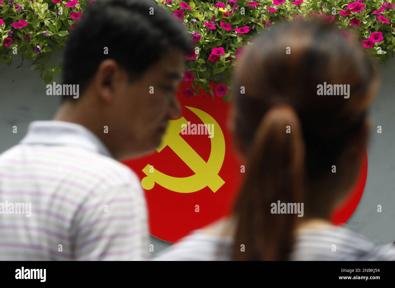 A couple walk past an advertisement to celebrate the upcoming 90th ...