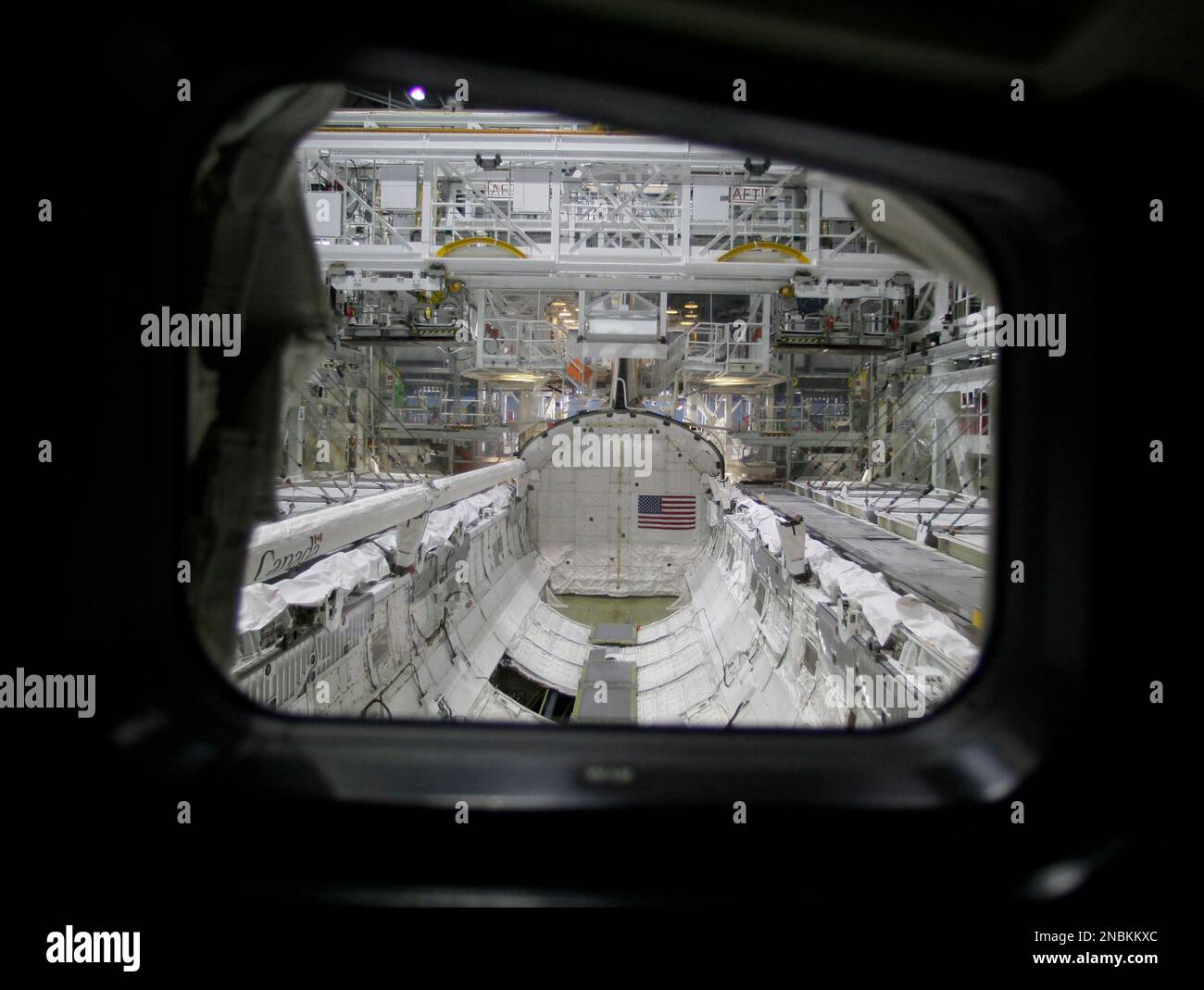 The payload bay is seen from a window on the flight deck of space ...