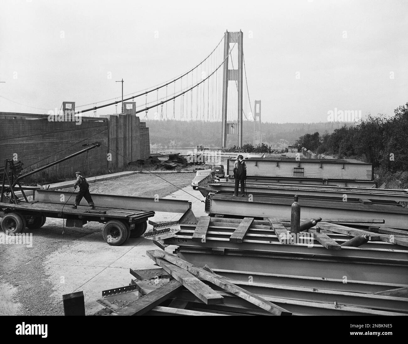 Workmen in foreground are loading steel girders on Sept. 4, 1942 being ...