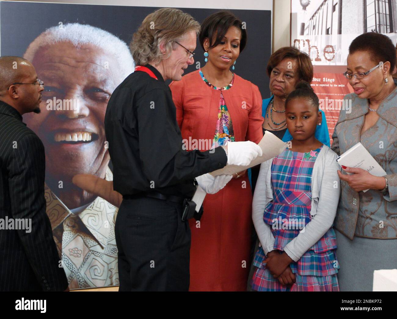 U.S. first lady Michelle Obama stands with daughter Sasha, her mother ...