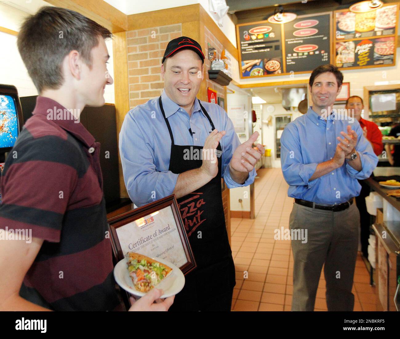 President of Miami-based Burger King, Steve Wiborg, center, with Pizza ...