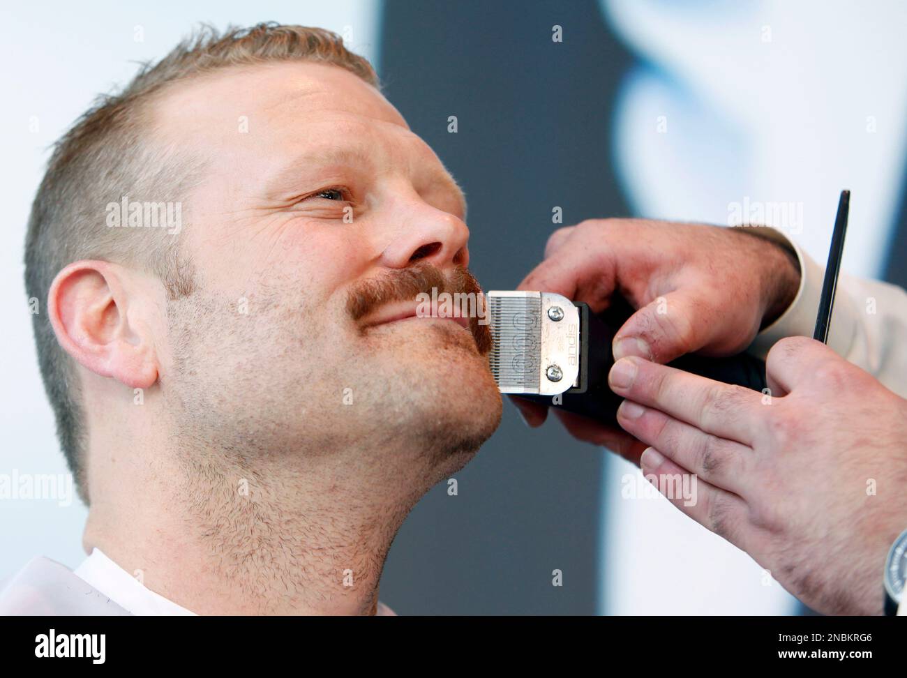 Boston Bruins goalie Tim Thomas has his beard shaved off during a ...