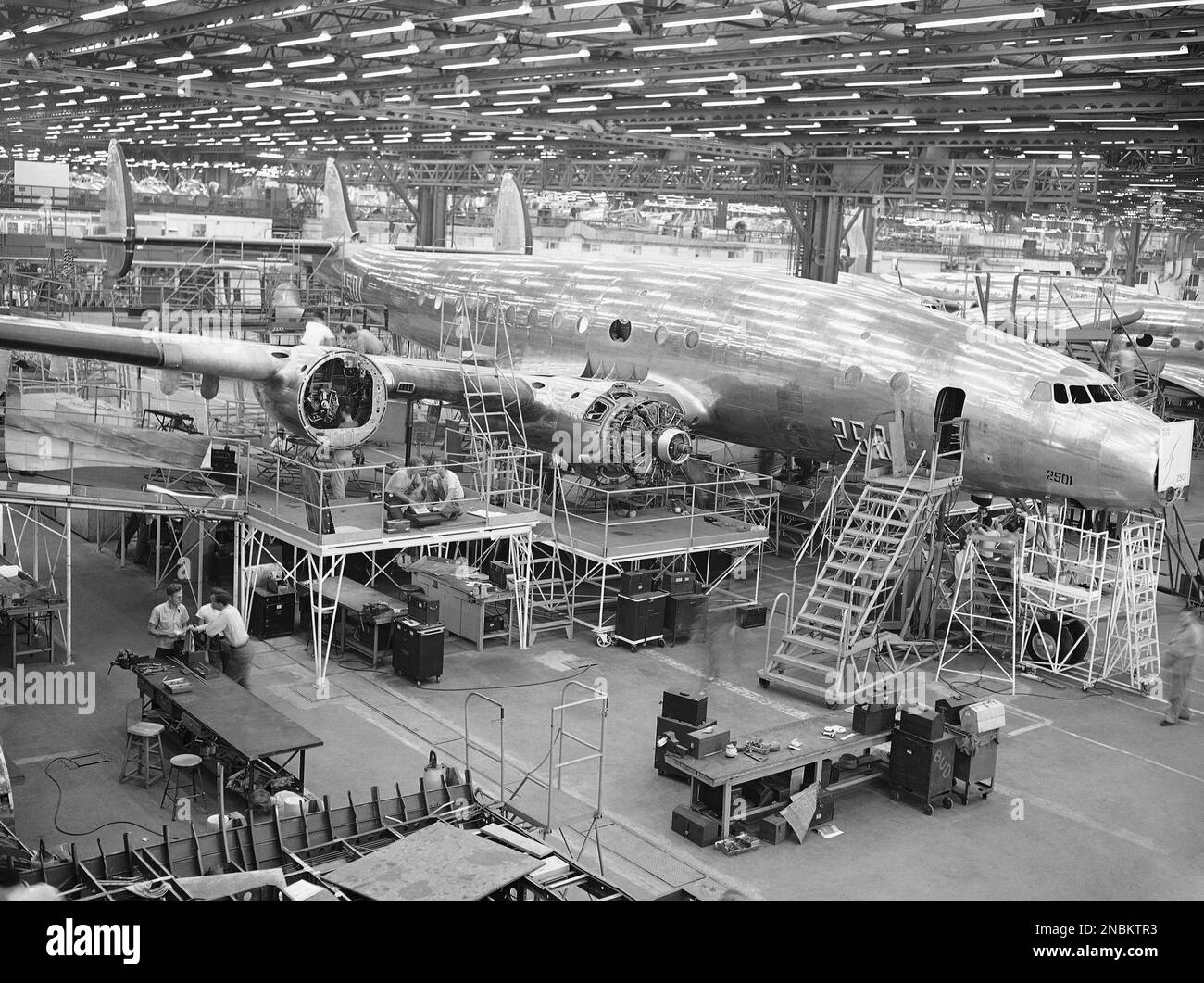 Lockheed Constellation on final assembly line with engine being ...