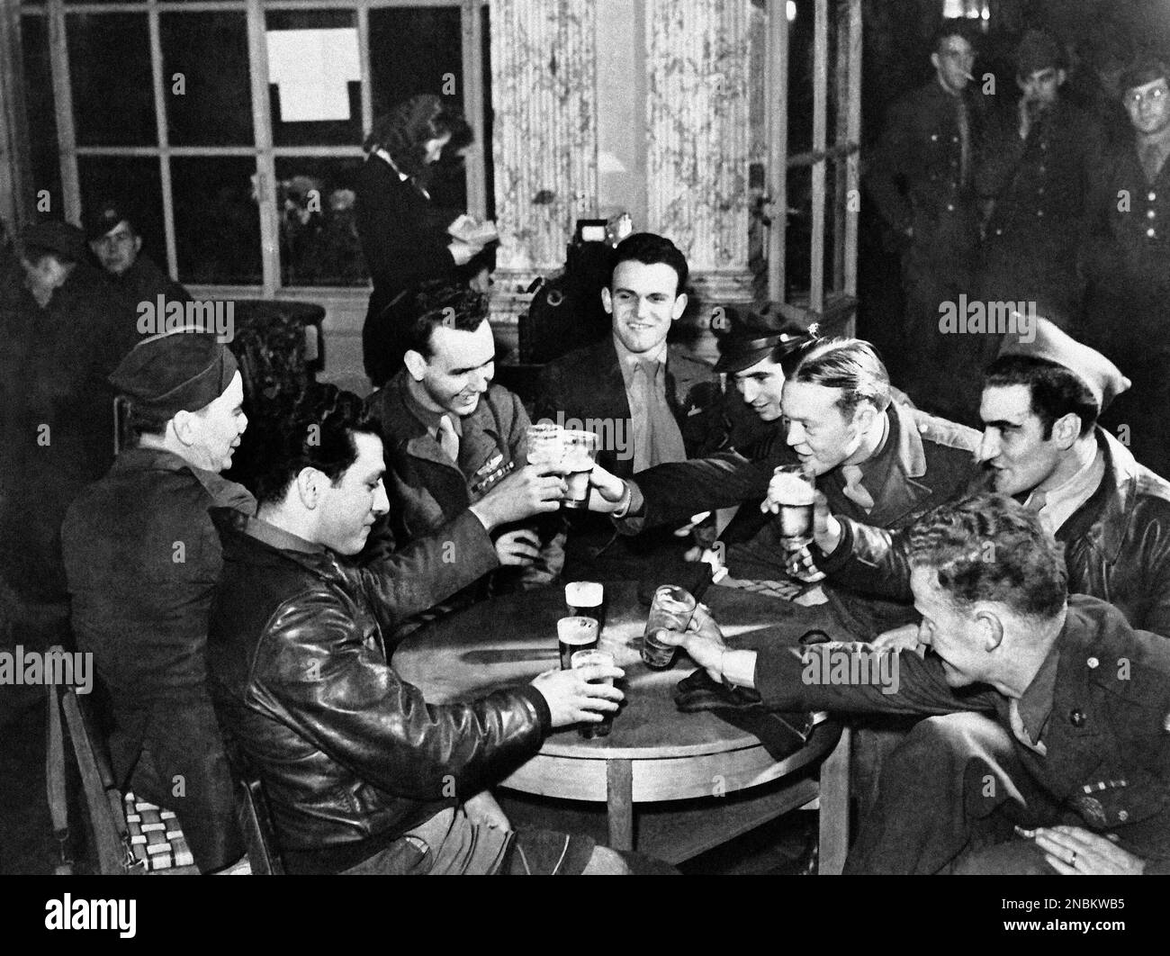 Some 9th Air Force pilots toast one of their members who has finished ...