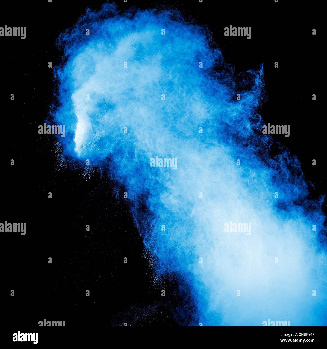 Blue dust explosion on black background. Freeze motion of color powder ...
