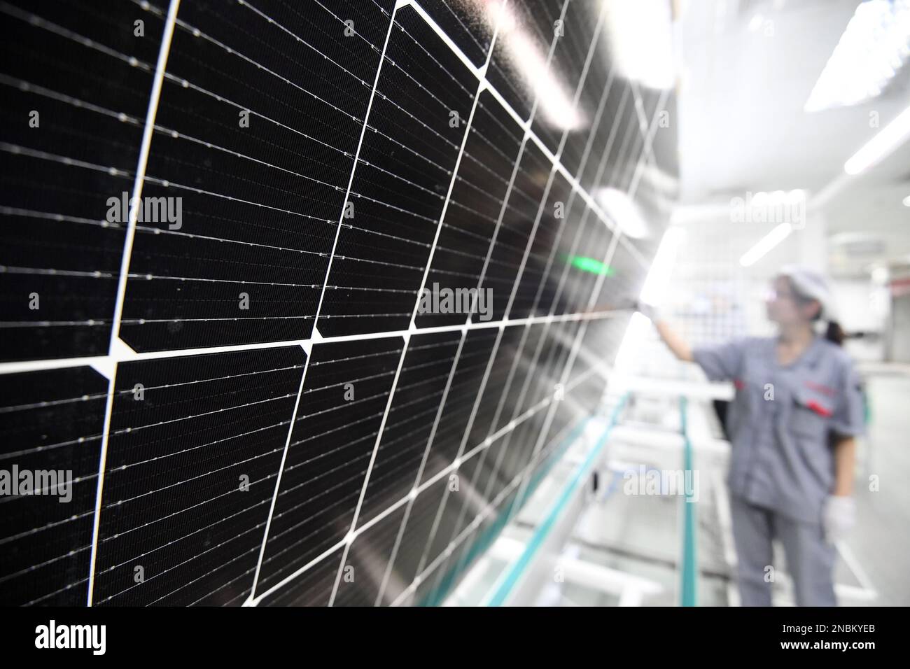 ZHANGJIAKOU, CHINA - FEBRUARY 14, 2023 - A worker works on a solar ...