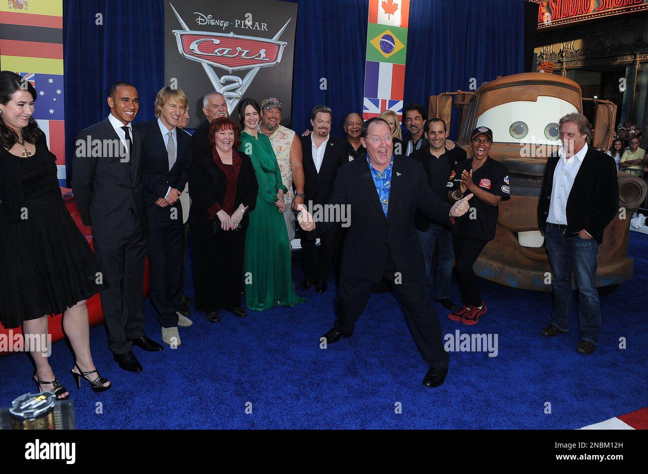 John Lasseter, at center, poses in front of the cast and crew at the ...