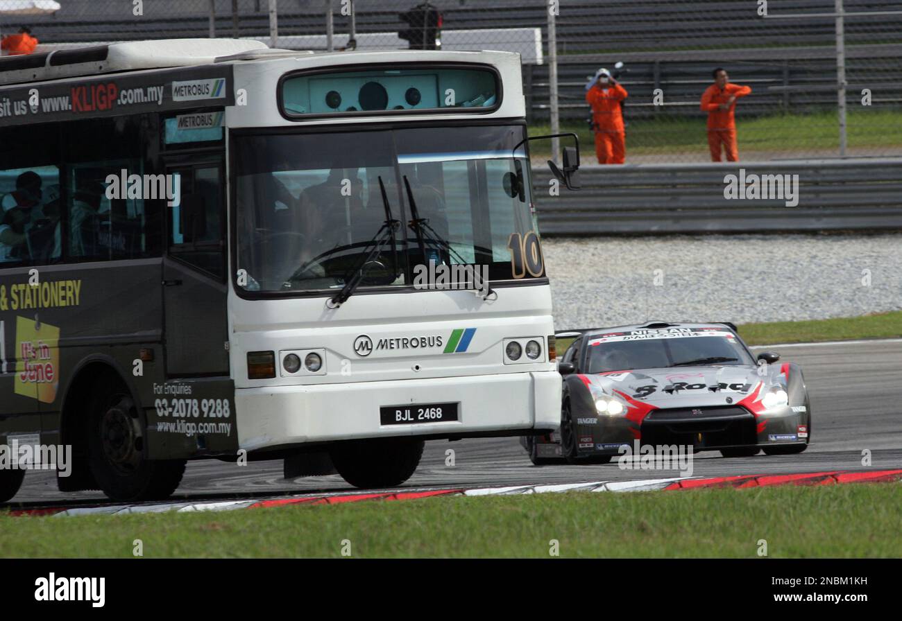 Auto racing fans watch Japan GT race cars from a bus during the Japan ...