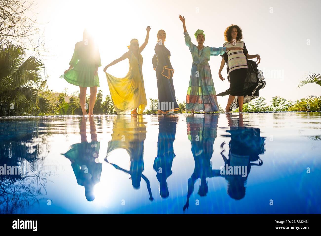 Group of beauty models on the edge of a swimming pool Stock Photo - Alamy