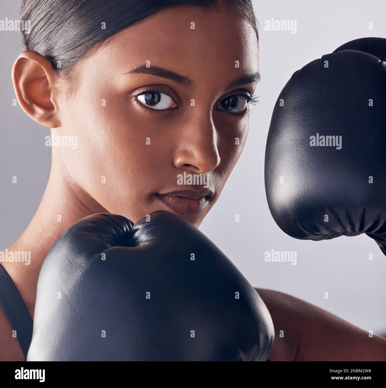 Boxing, gloves and portrait face of woman in studio for exercise ...