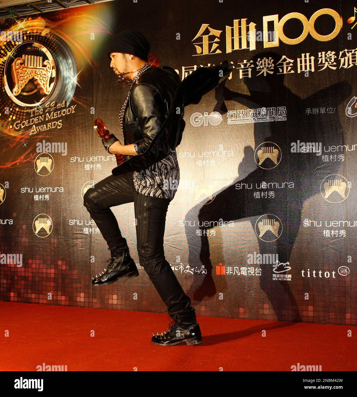 Taiwanese singer Jay Chou twirls as displays his awards for "Best Male ...