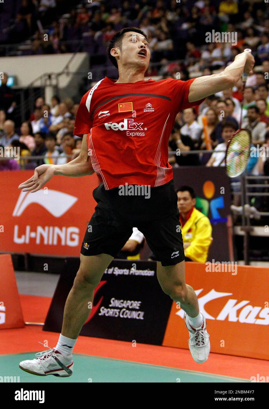 Lin Dan of China returns a shot to Peter Gade of Denmark during the Li ...