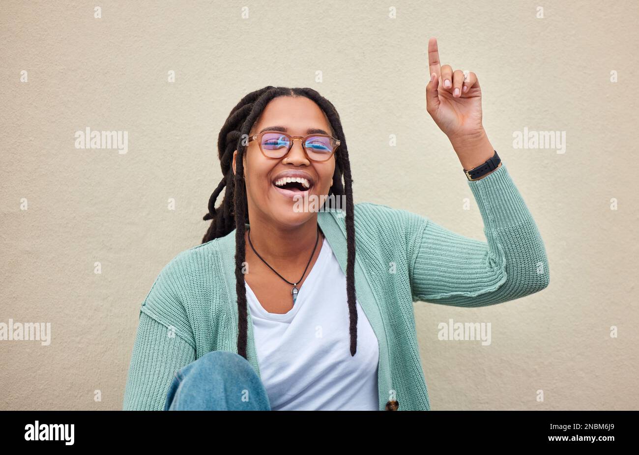 Up sign, portrait and black woman pointing with mockup in studio for advertising, space and wall ...