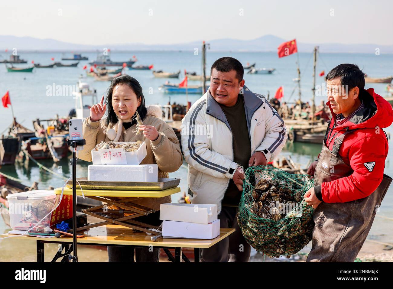 QINGDAO, CHINA - FEBRUARY 14, 2023 - Anchors sell seafood via ...