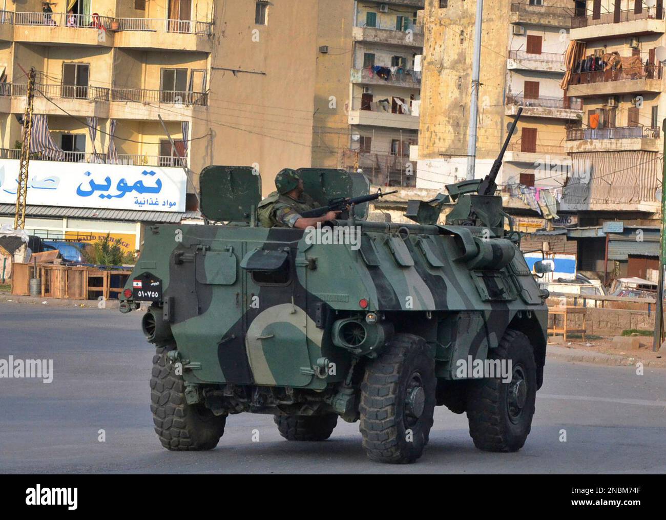 A Lebanese army soldier takes up a position on his armored personnel ...