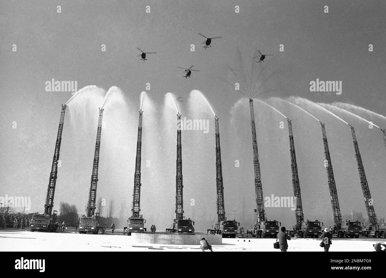 Helicopters from the Tokyo Fire Department hover over fire engine ...
