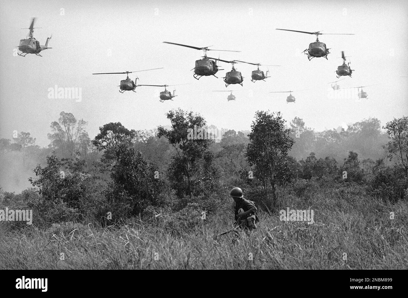 Hovering U.S. Army helicopters pour machine gun fire into tree line to ...