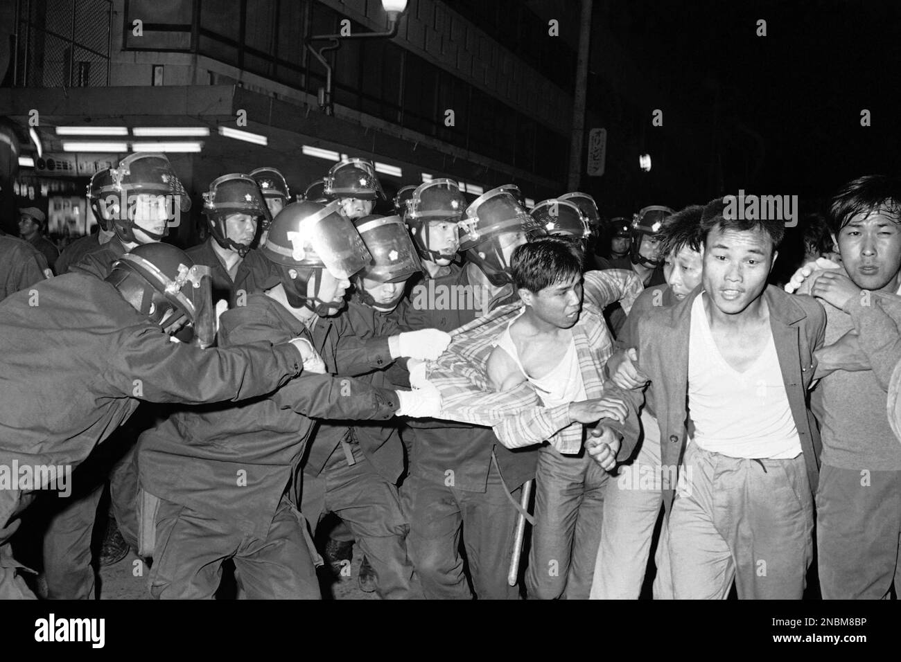 Japanese riot police clash with some 300 demonstrators at the gate of ...