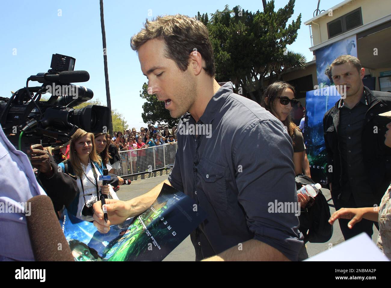 Actor Ryan Reynolds signs an autograph as he works his way through a ...