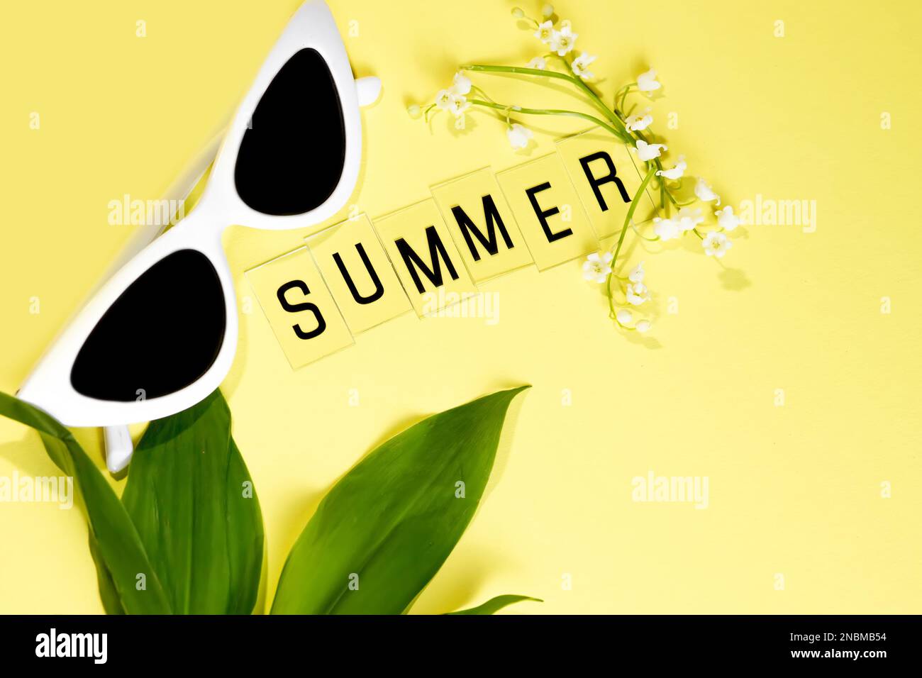 Summer layout of flowers, leaves, glasses and text with the inscription ...