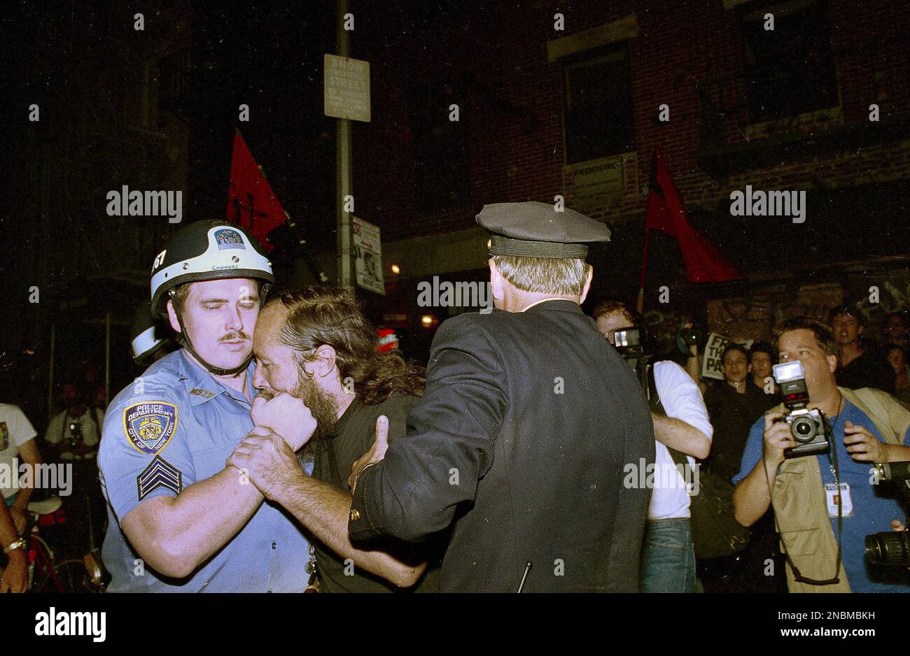 Police grab a demonstrator by the beard as they arrest him as violence ...